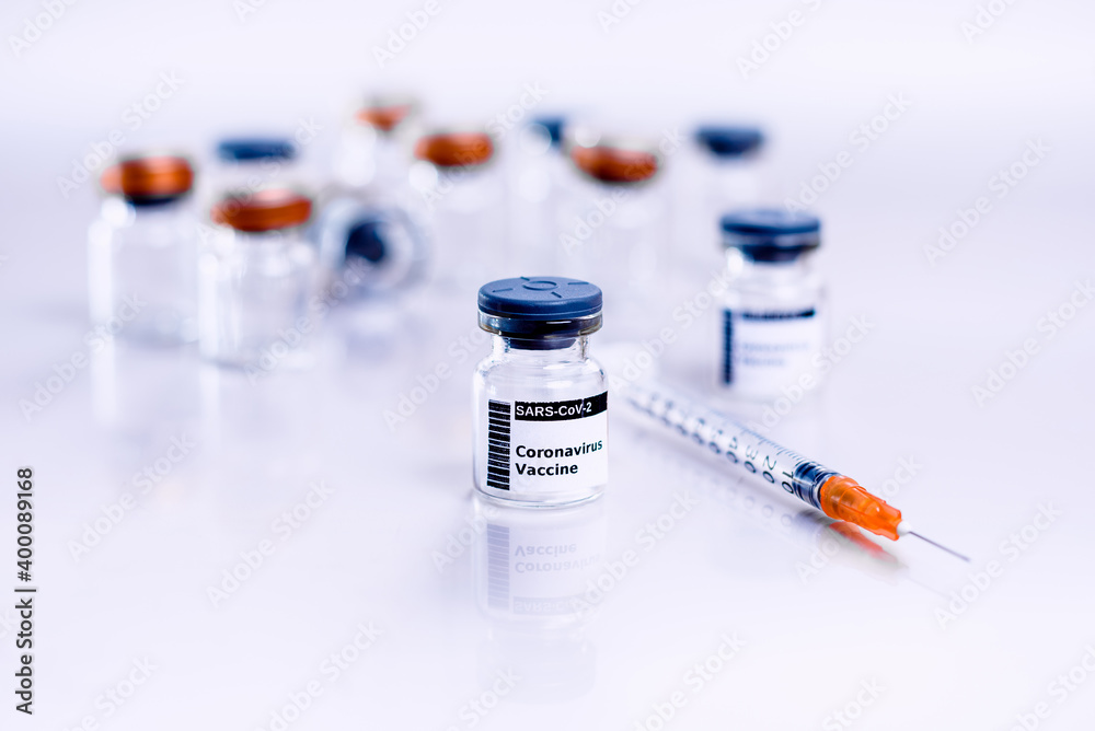 Vials of the coronavirus (COVID-19) vaccine are administered through a ...