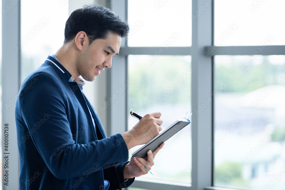 Thinking of asian young businessman working with read the note recorded ...