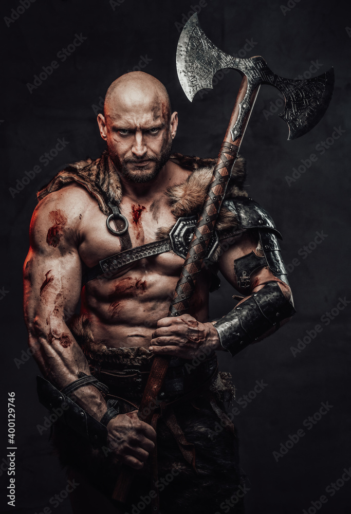 Serious and furious barbarian with bald head and grimy and bloody skin ...