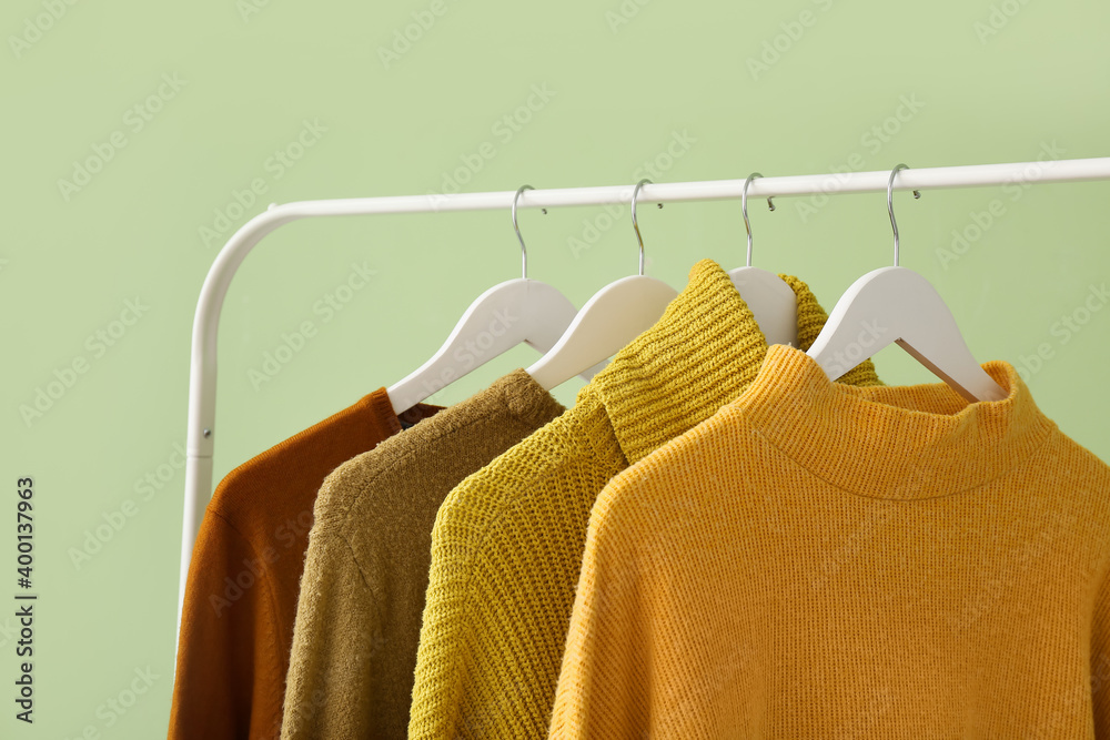 Rack with clothes on color background Stock Photo | Adobe Stock