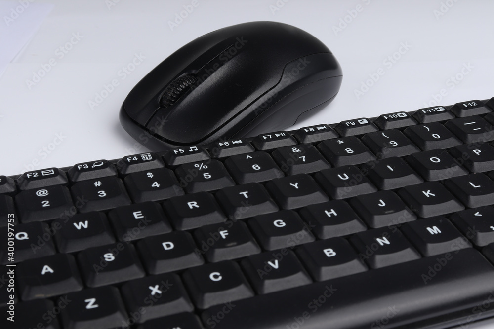 black mouse and keyboard with isolated white background. technology ...