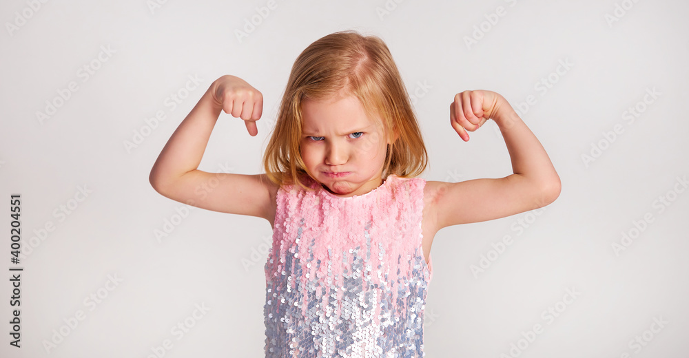 Little girl shows her strong. Beauty young girl showing the strength of ...