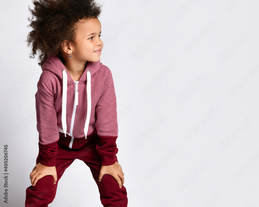 Fashion advertising in childhood. Dark skinned school age girl dressed ...