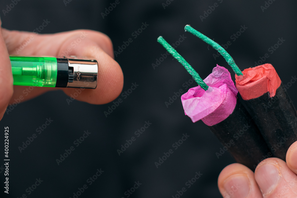 Setting Fire to the several Firecrackers. Man in Black Clothes Lighting ...