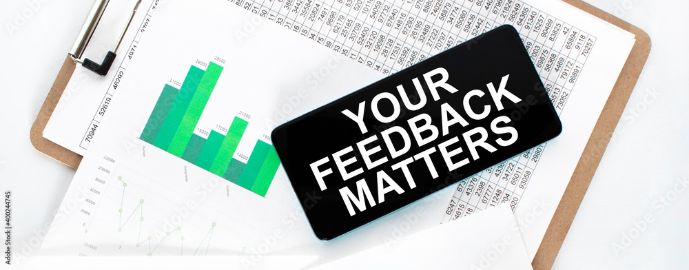 Paper plate with financial amounts, green diagram and phone with text ...