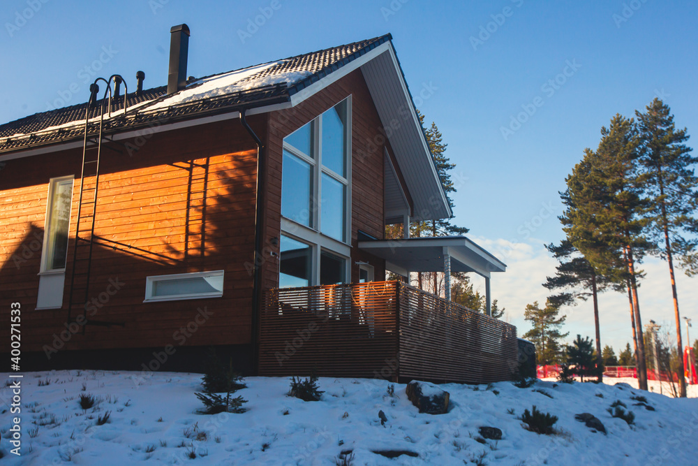 A view of cozy wooden scandinavian cabin cottage chalet house covered ...
