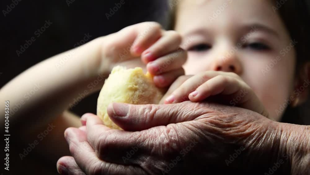 An old grandmother eats bread crumbs from her palm. Grandmother eats ...