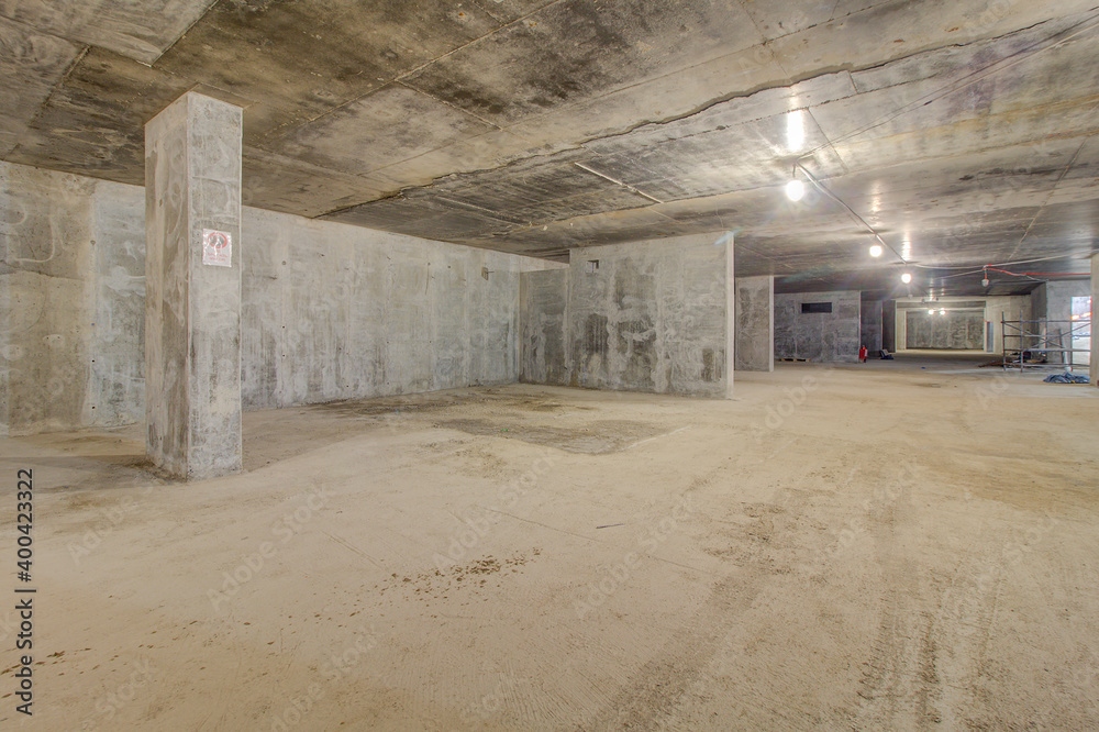 Underground parking in construction phase. Empty garage in basement of ...