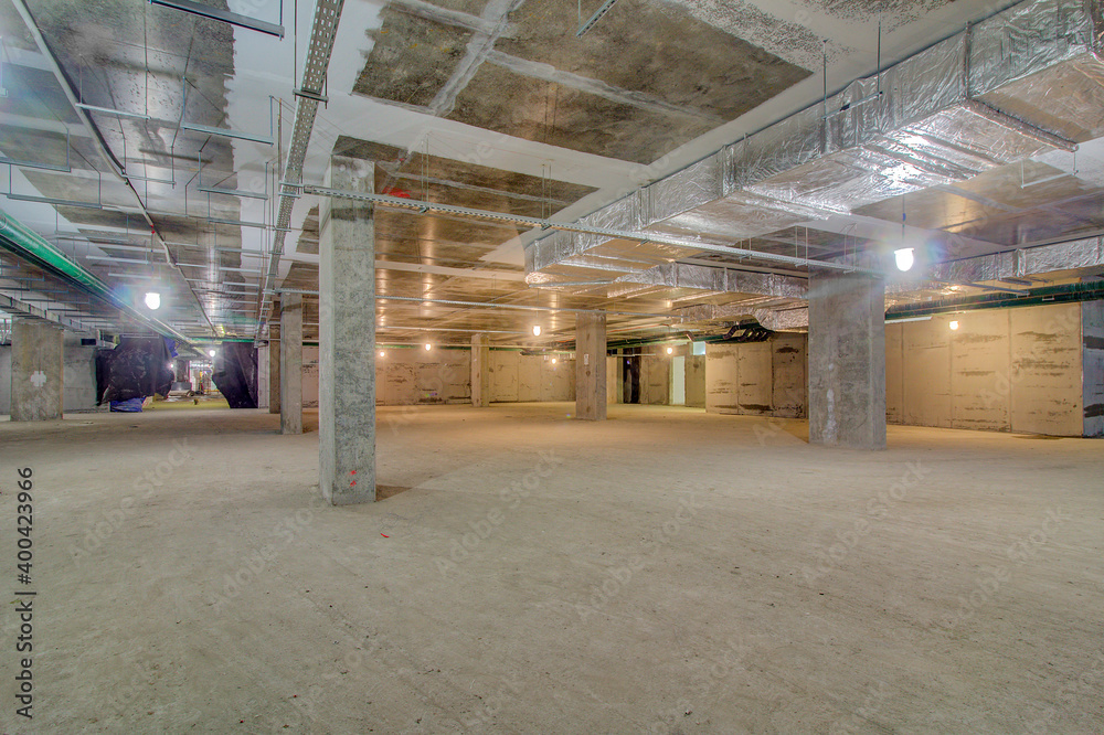 Underground parking in construction phase. Empty garage in basement of ...