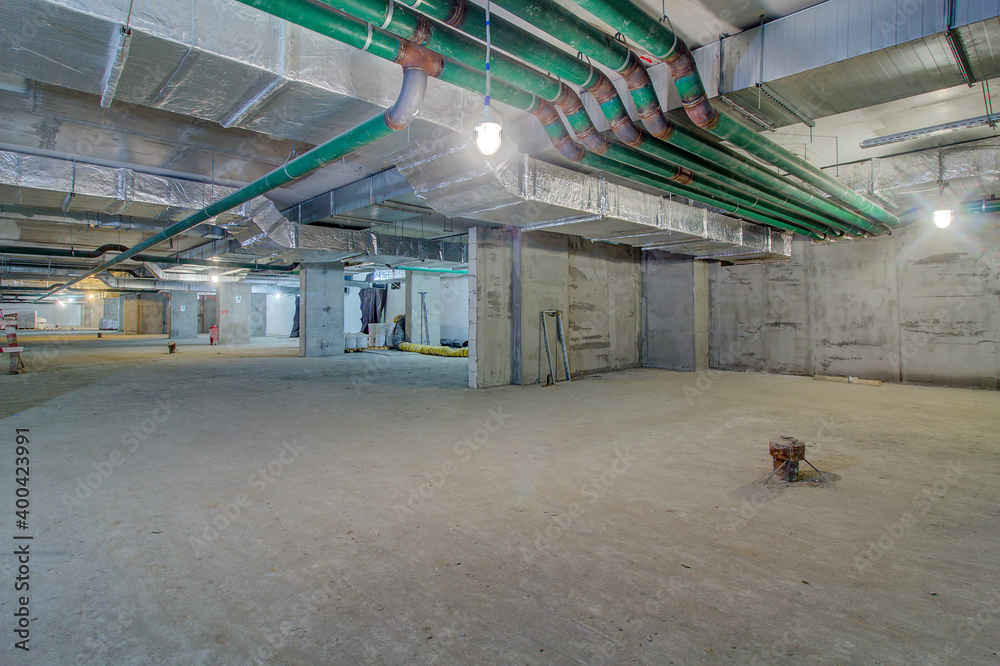 Underground parking in construction phase. Empty garage in basement of ...