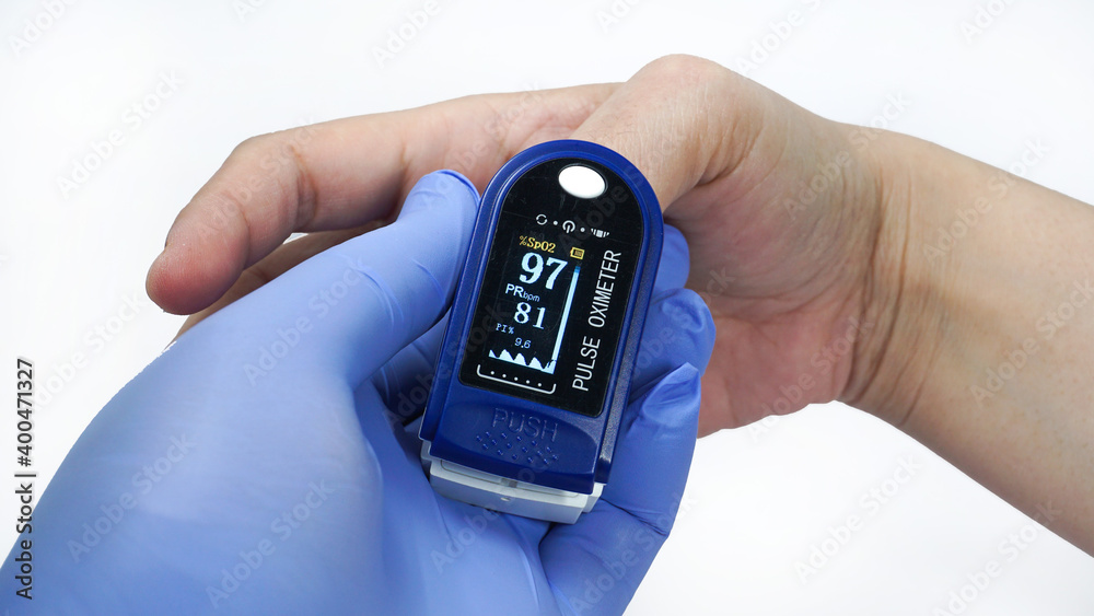 Pulse oximeter used to measure pulse rate and oxygen levels Stock Photo ...