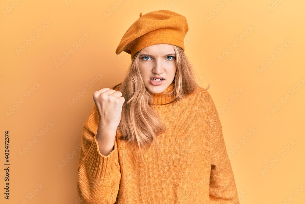 Beautiful young caucasian girl wearing french look with beret angry and ...