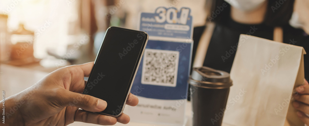 customer hand using digital mobile phone scan QR code paying for buying ...