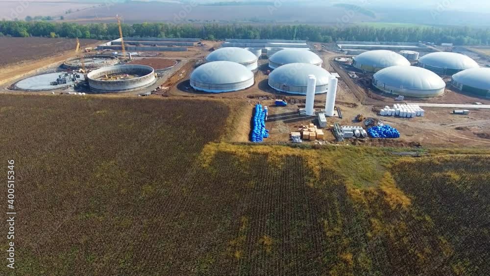 Construction of biogas plant on field. Large storage reservoirs for ...
