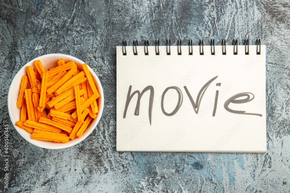 top view cheese rusks with movie written notepad on light background ...