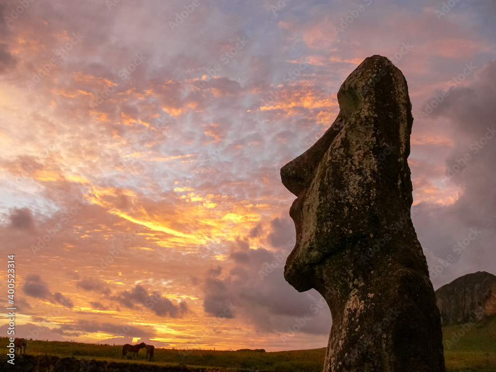 Statues of Easter Island in the background of the sunset. melting of ...