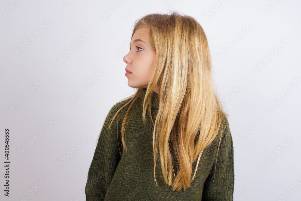 Close up side profile photo Caucasian kid girl wearing green knitted ...