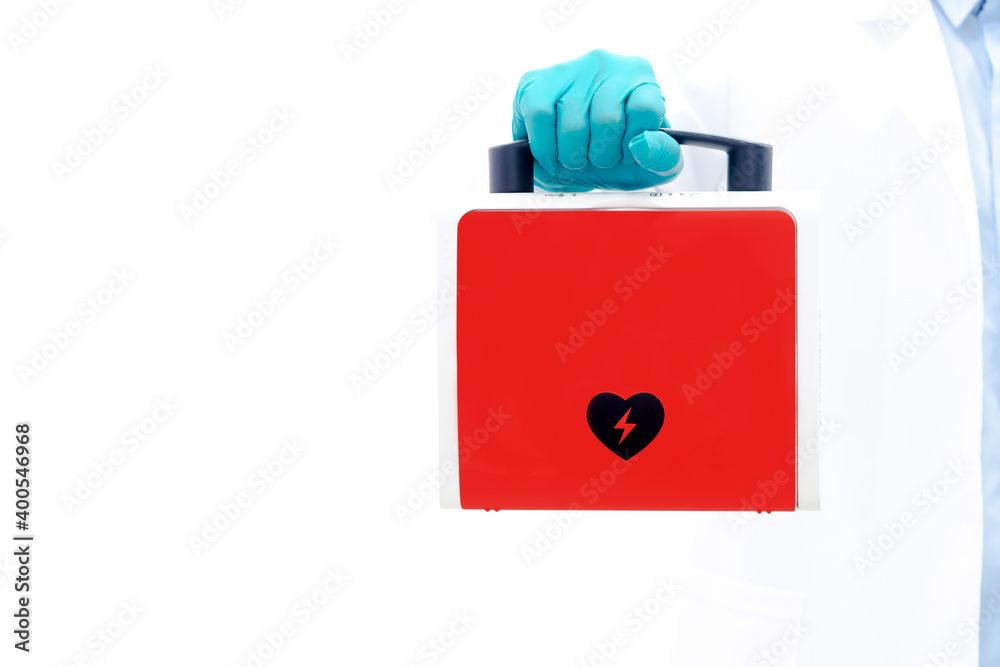 Aed rescue equipment Or a red heart defibrillator In the doctor's hand ...