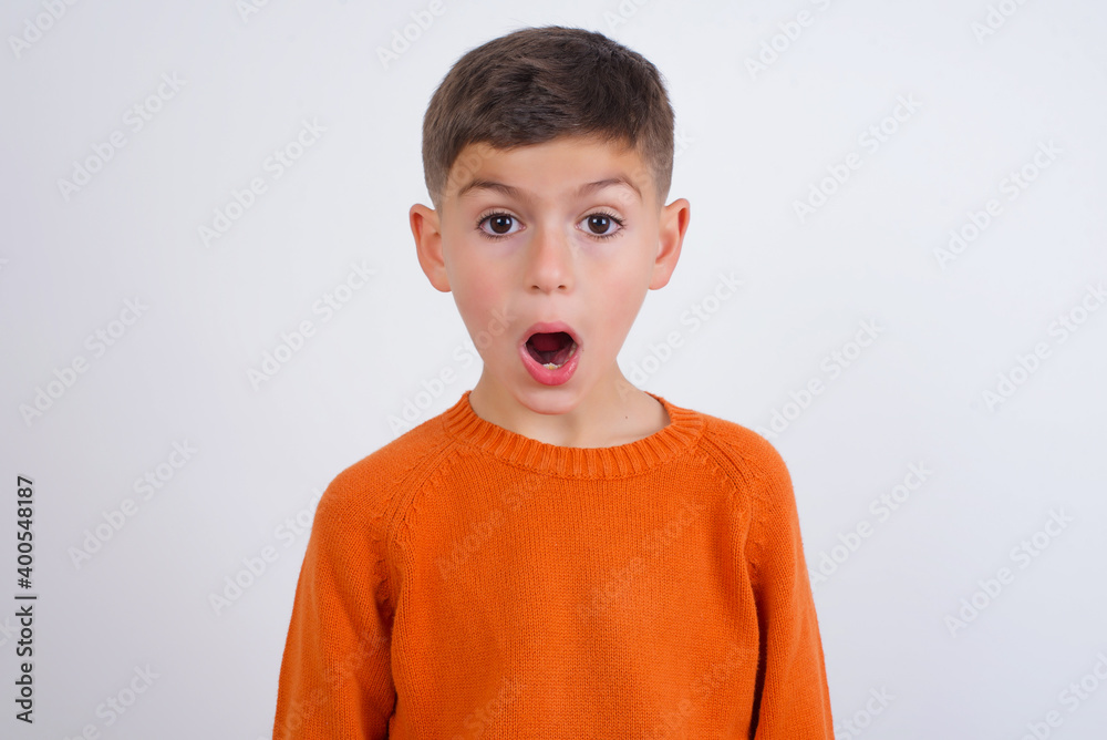 Oh my God. Surprised Cute Caucasian kid boy wearing knitted sweater ...