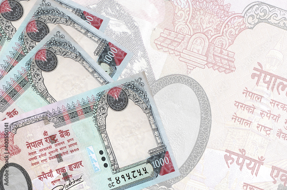 1000 Nepalese rupees bills lies in stack on background of big semi ...