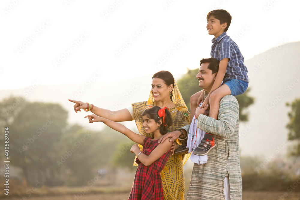 Happy rural Indian family on agricultural field Stock Photo | Adobe Stock