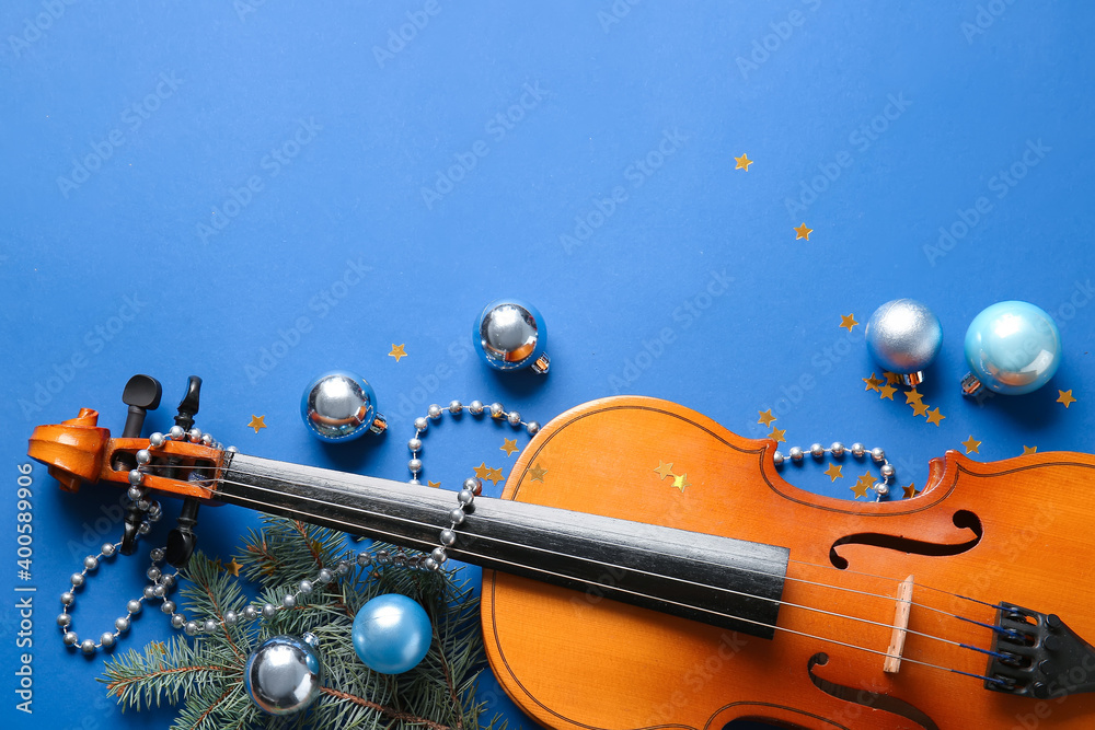 Violin with Christmas decor on color background Stock Photo | Adobe Stock