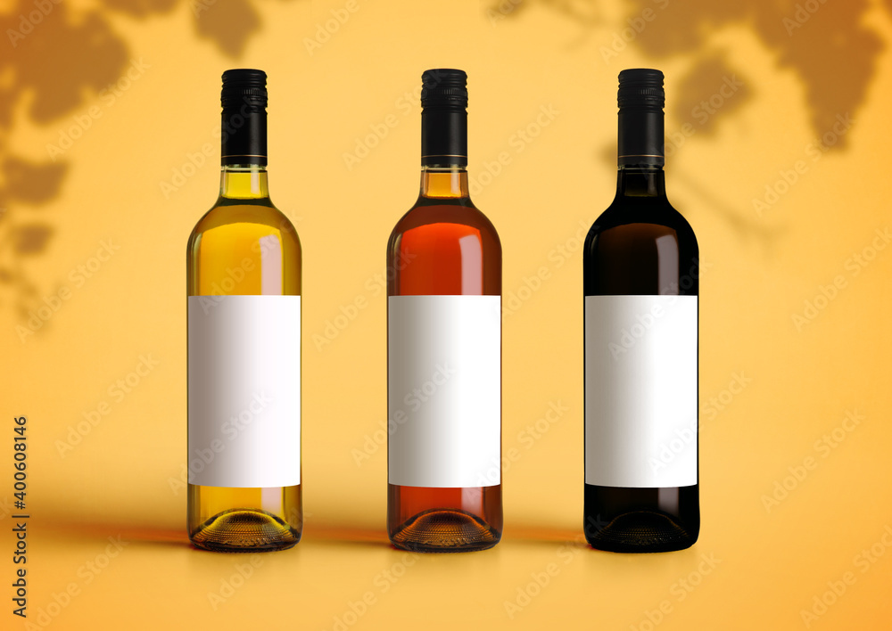 Mockup of three types of wine bottles on a yellow background. Empty ...