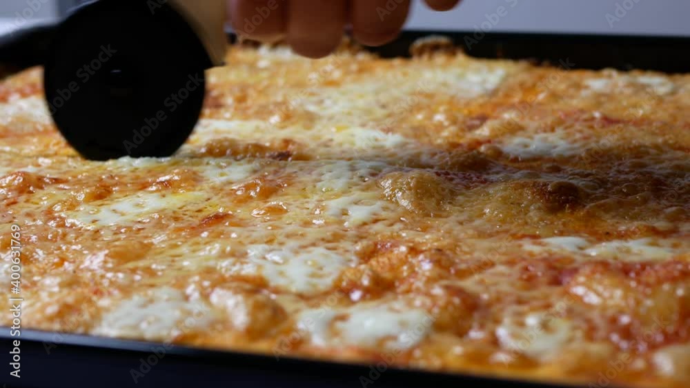Cutting pizza into pieces using a round cutter knife, Delicious ...