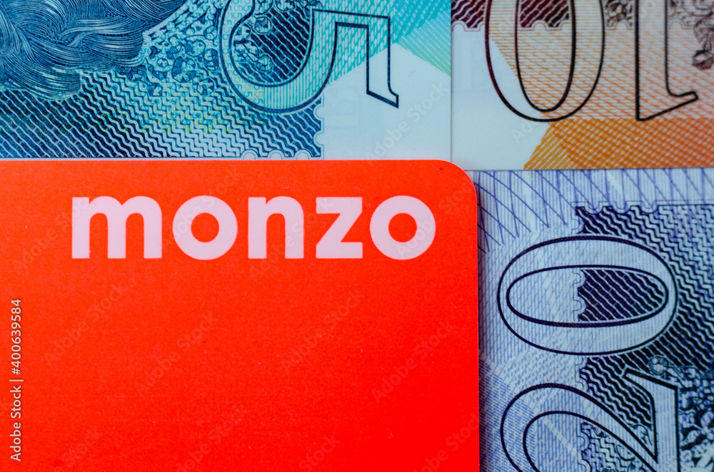 Monzo bank card logo on a vibrant background of blurred British pounds ...
