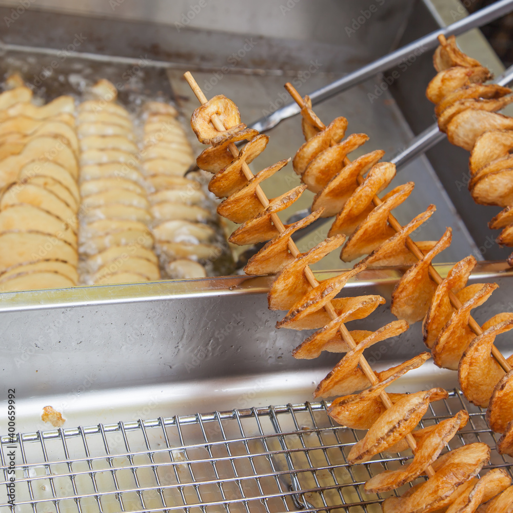 Street food-deep fried spiral potato (chips on a stick) Stock Photo ...