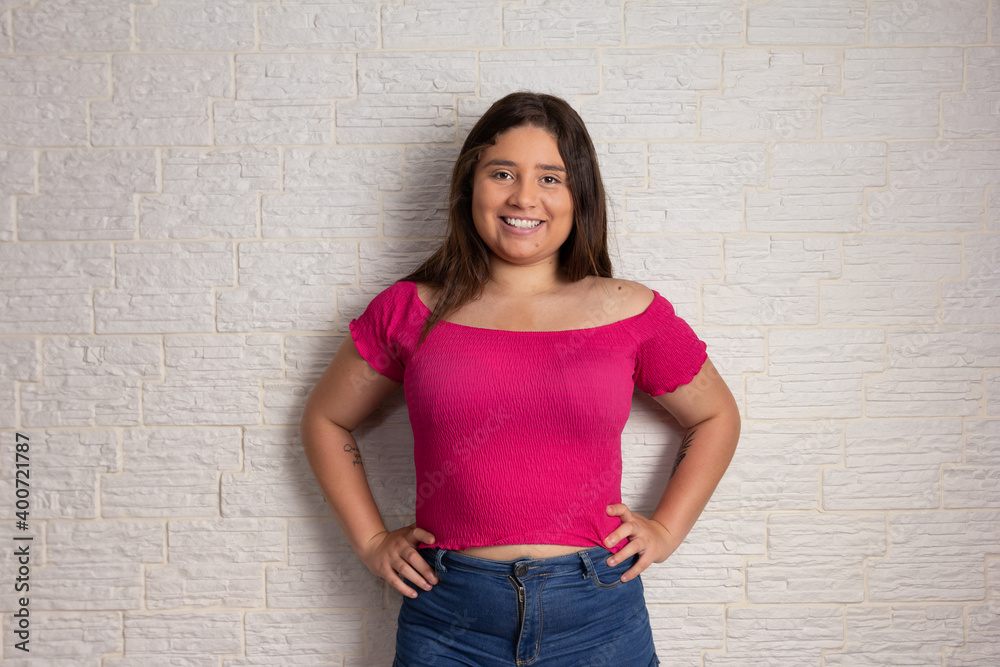 Portrait of Happy body positive plus size woman with arms in the hips ...