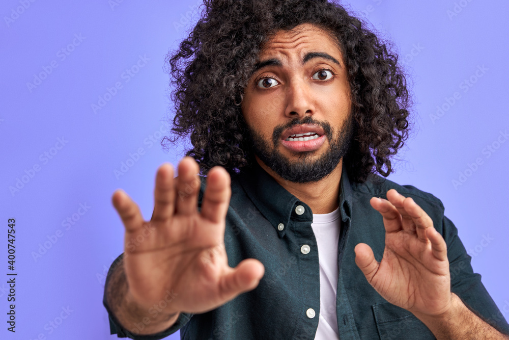 man has panick attack. young arab man is terrified with fear expression ...