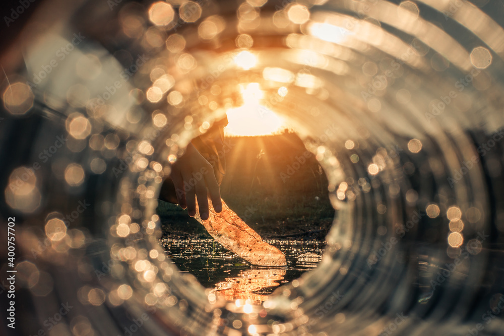 hand holding plastic bottle inside the bottle view on the river with ...