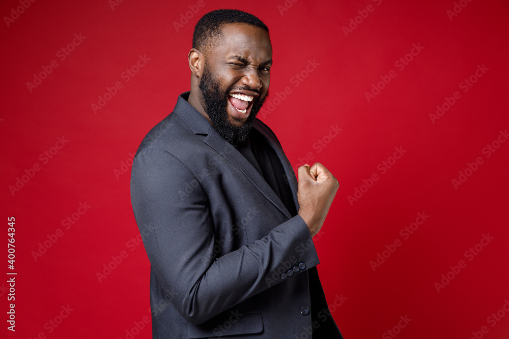 Side view of joyful happy blinking young african american business man ...
