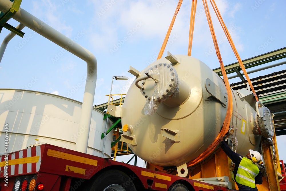Foto de Large chemical tank are being lifted up for installation in the ...