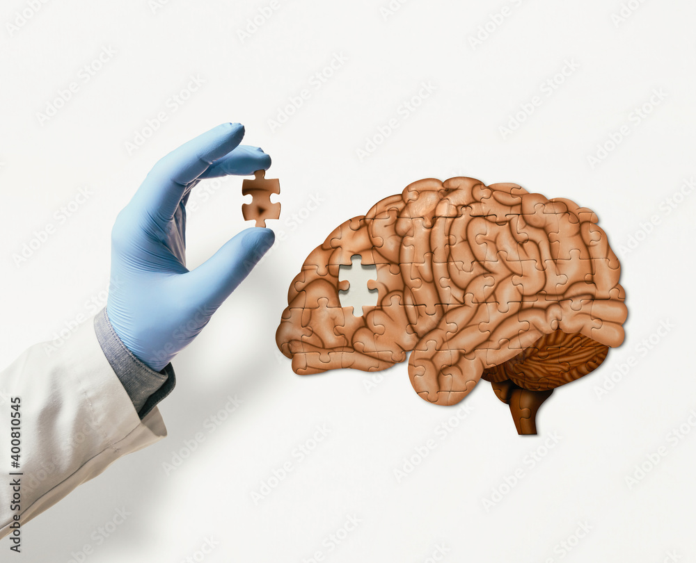 Puzzle with illustration of human brain and doctor hand with the ...