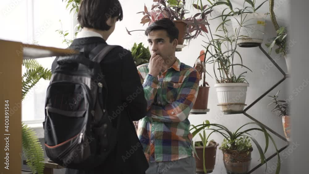 Teenagers passing drugs in high school corridor. Nervous Caucasian boy ...