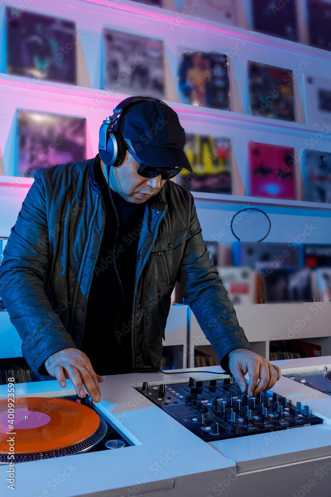 Foto de Dj mezclando música en un tornamesa con discos de vinil, y ...