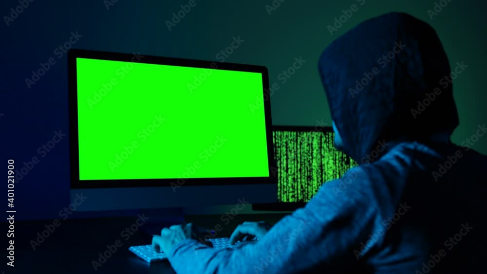 Man in black hoodie, working in a Dark underground office room, on a ...