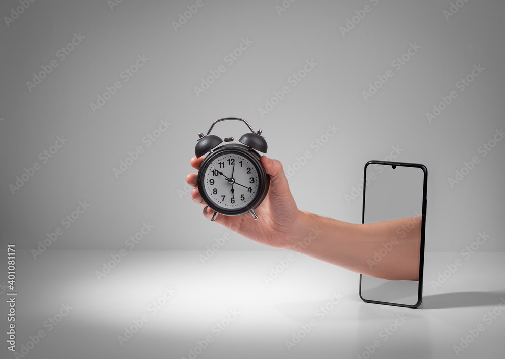Hand showing a vintage alarm clock through a phone screen Stock Photo ...