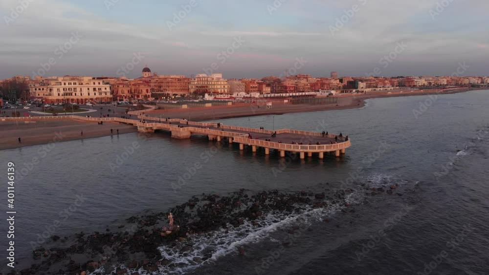 Scenic sunset aerial view over cliff to Rome sea in Ostia lido pov of ...