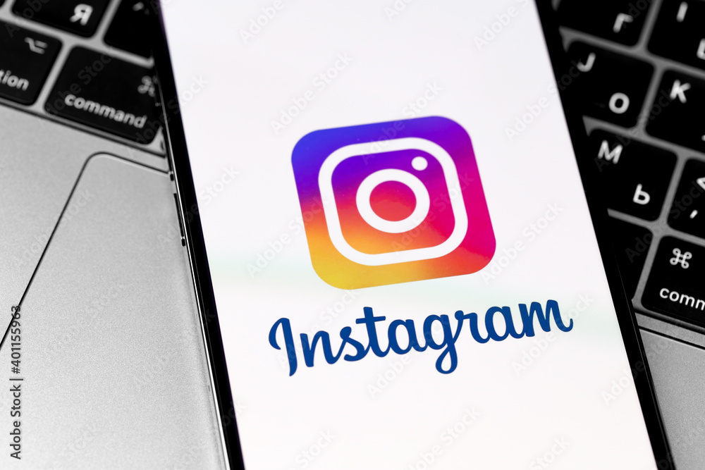 Instagram logo on the screen iPhone and MacBook closeup. Instagram is a ...