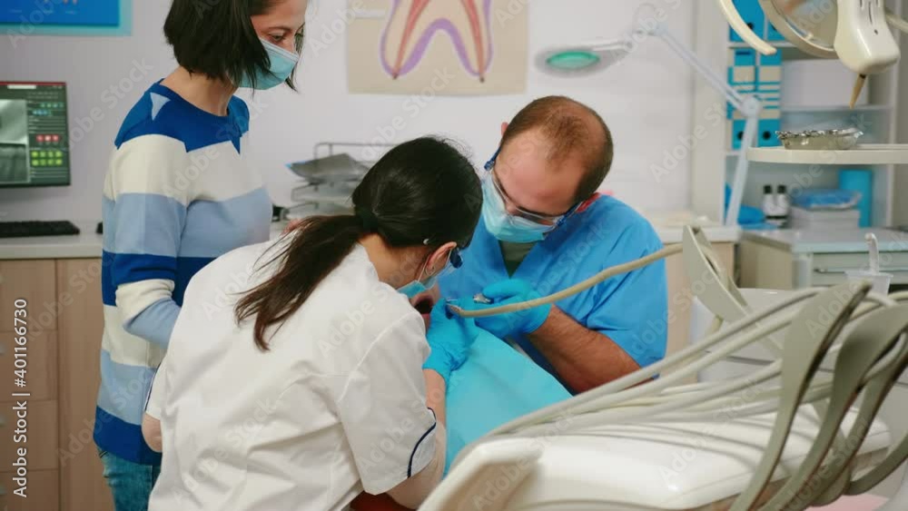 Child sitting in stomatological chair opening mouth for exemination, in ...