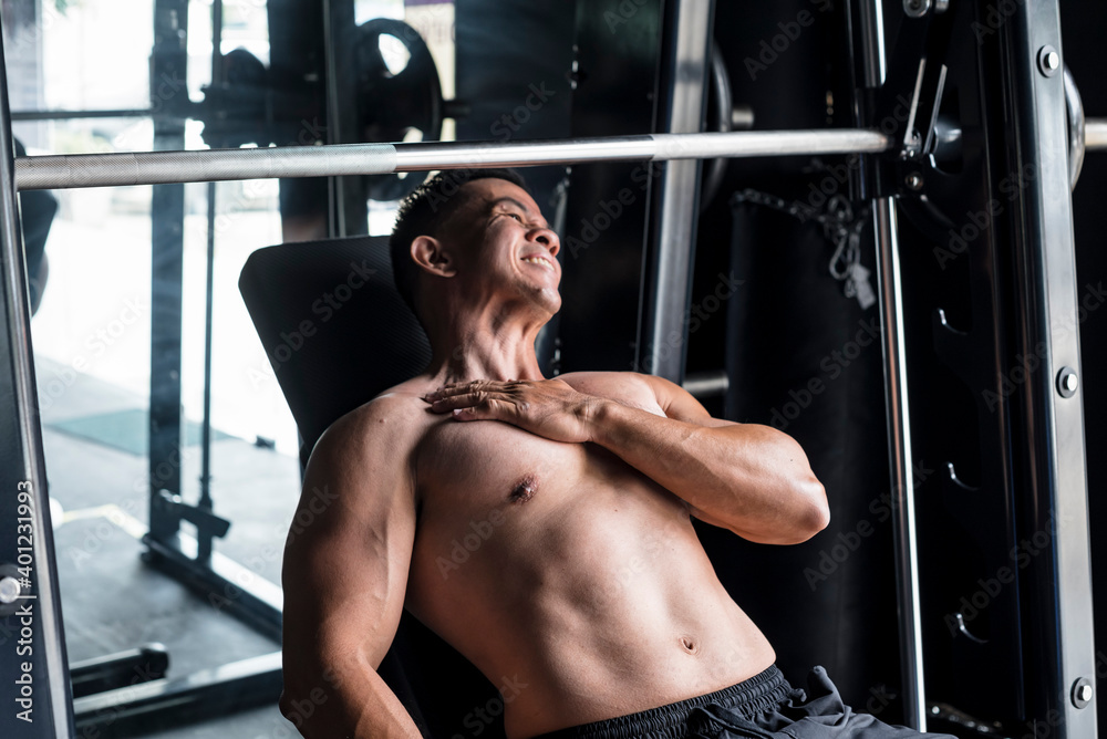 An asian male bodybuilder suffers a torn pectoral muscle while doing ...