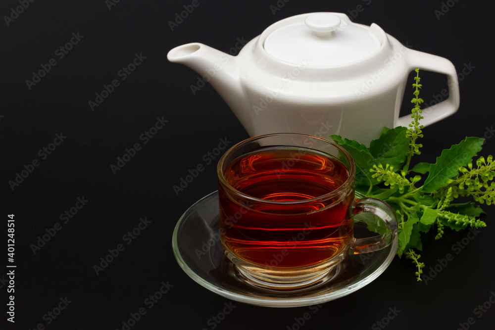 Holy Basil or tulsi tea in transparent glass cup and holy basil leaf on ...