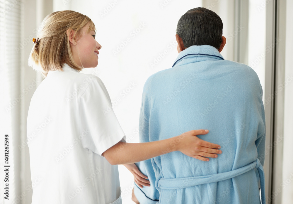Nurse assisting patient with a walker Stock Photo | Adobe Stock