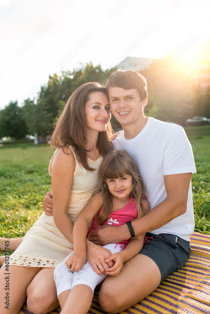 Young family man woman child daughter 5-7 years old, summer park ...