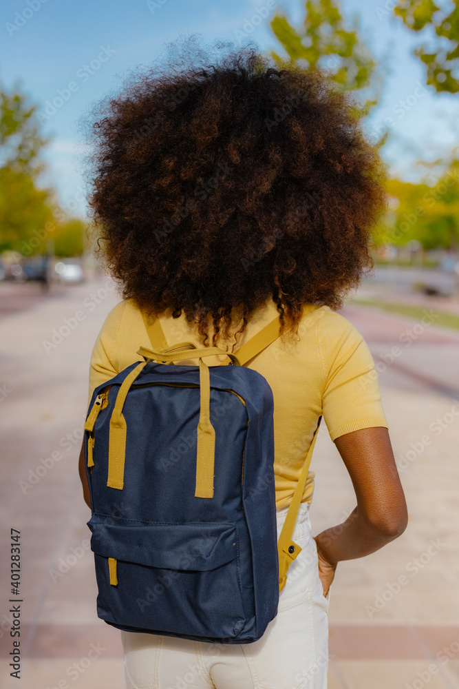 Back view black woman with afro hair with a backpack on her back Stock ...