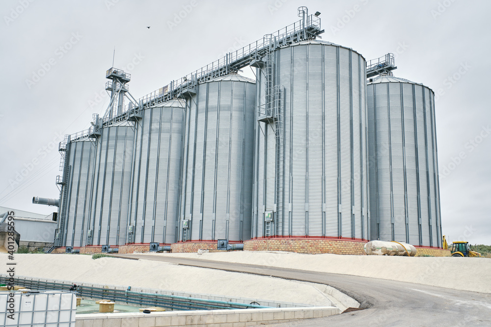 Low angle of huge steel agricultural silo towers located at factory ...