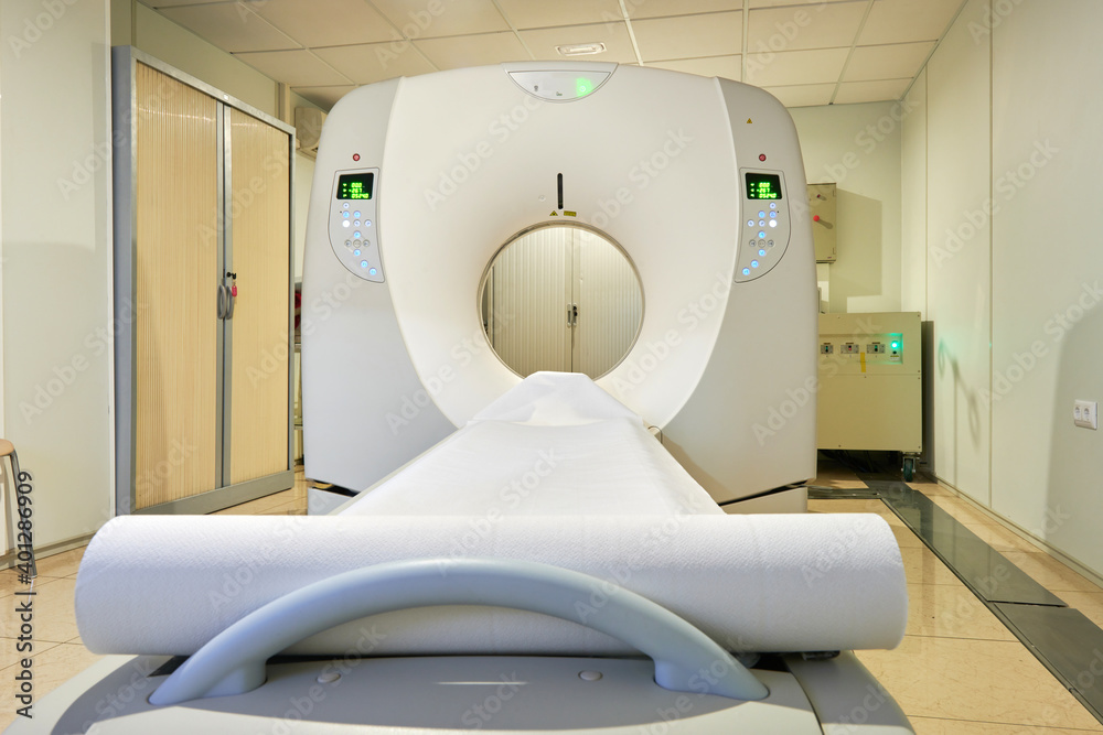Contemporary computerized tomography scan machine with couch and gantry ...